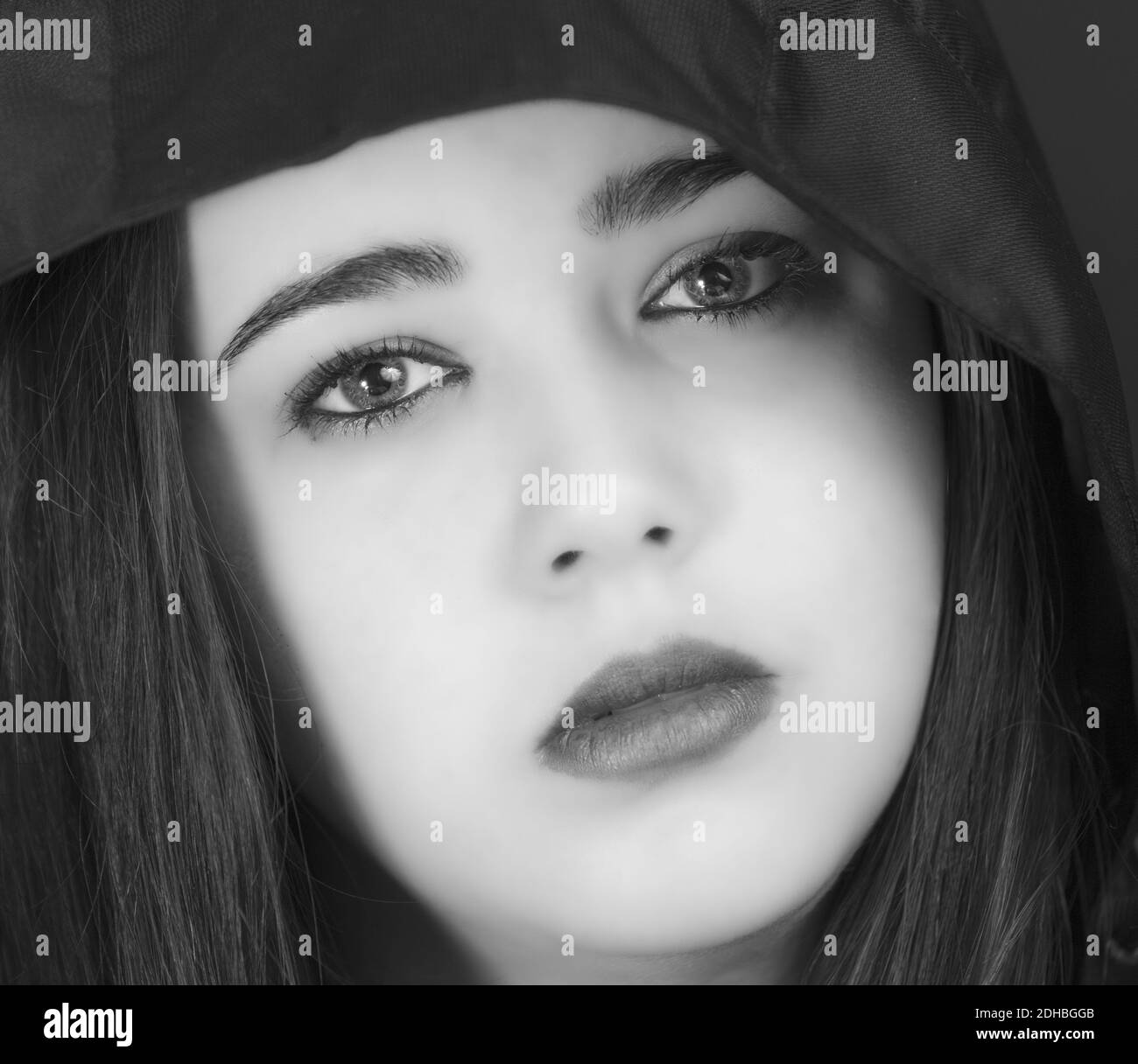 A portrait of young woman covered with a hood Stock Photo - Alamy