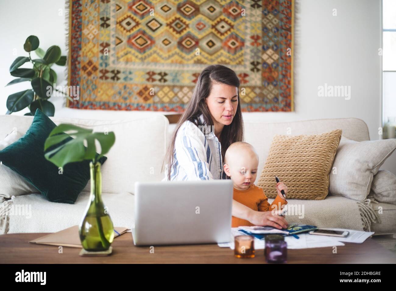Busy female parent running business while taking daughter's care at ...