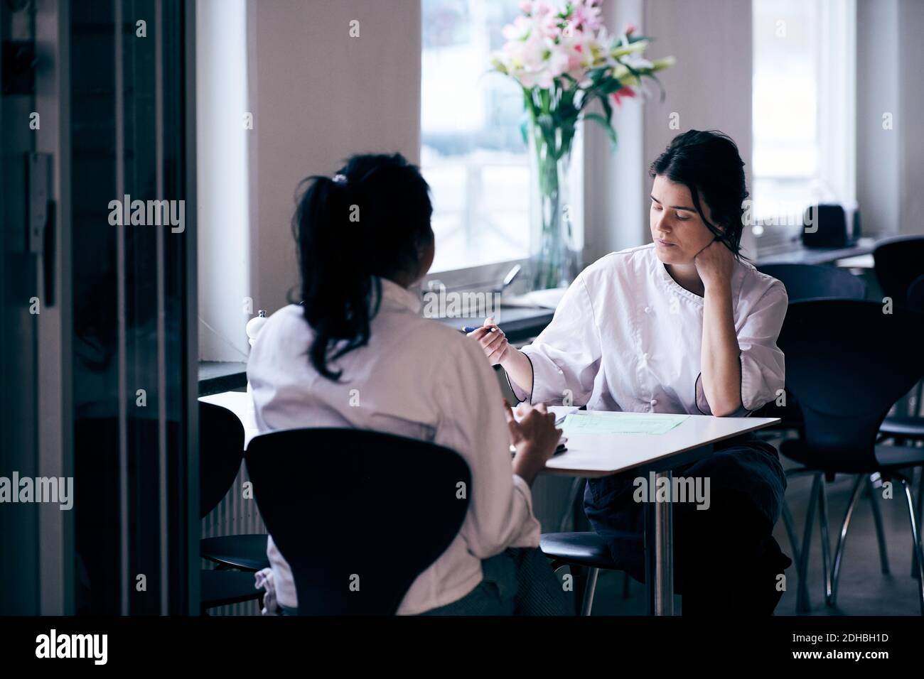 Chefs discussing menu in restaurant Stock Photo - Alamy