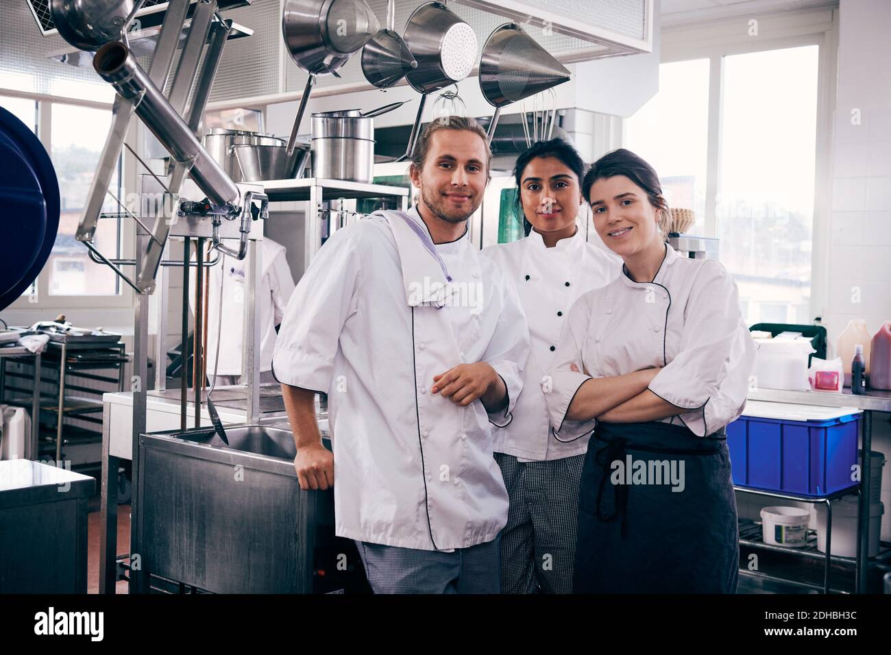Portrait of multi-ethnic chefs standing in commercial kitchen Stock ...