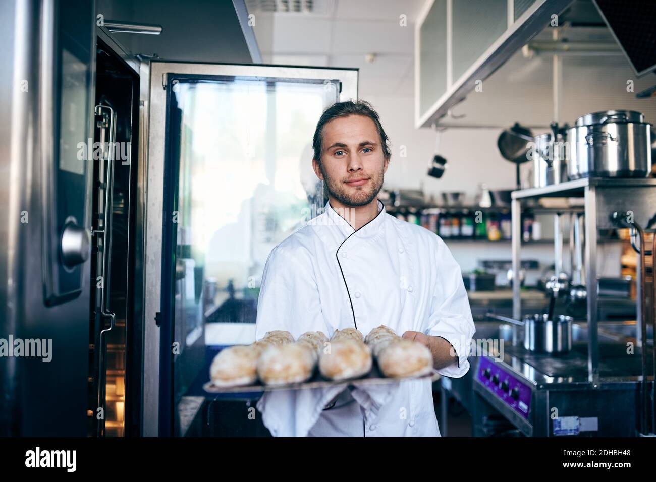 Portrait of chef baking breads in commercial kitchen Stock Photo - Alamy