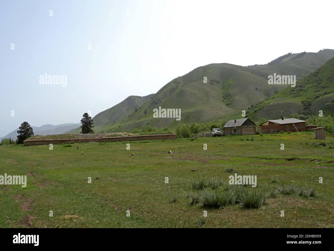 upland sheep farm with large covered sheepfold Tien Shan mountains ...