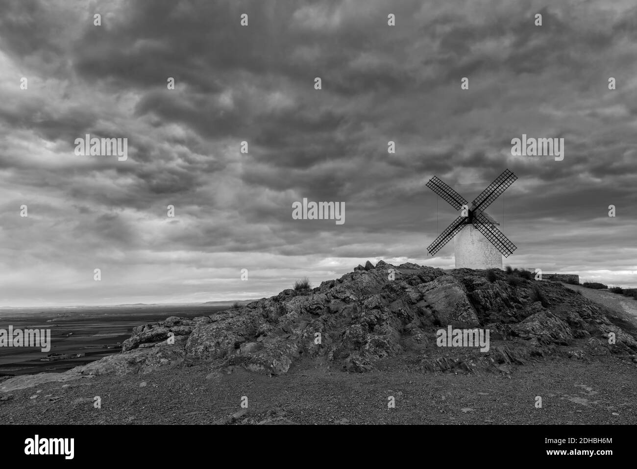 A grayscale of the traditional white windmill in Consuegra, Toledo ...