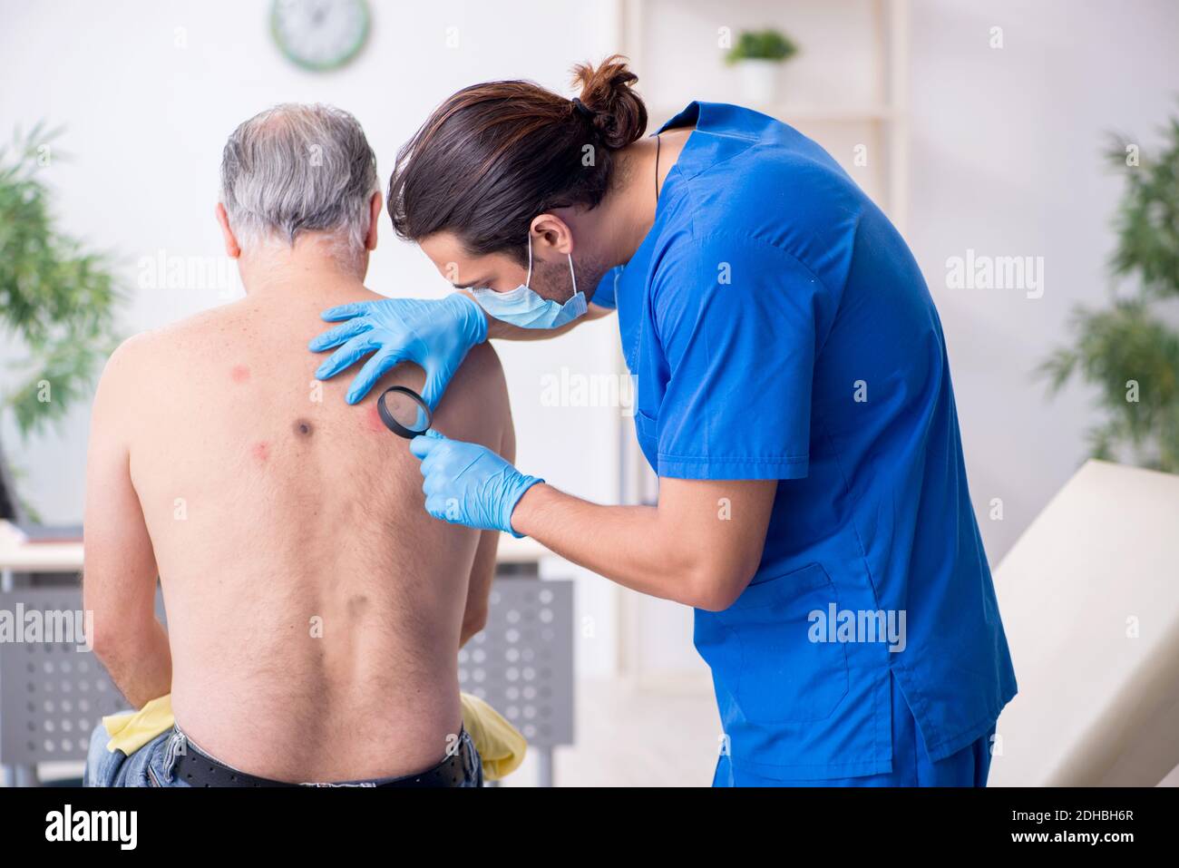 Old man visiting young male doctor dermatologist Stock Photo - Alamy