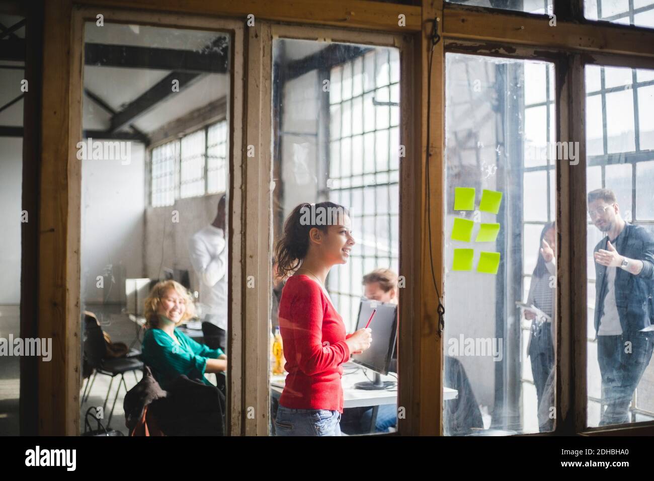 Computer professionals brainstorming in board room while discussing ...