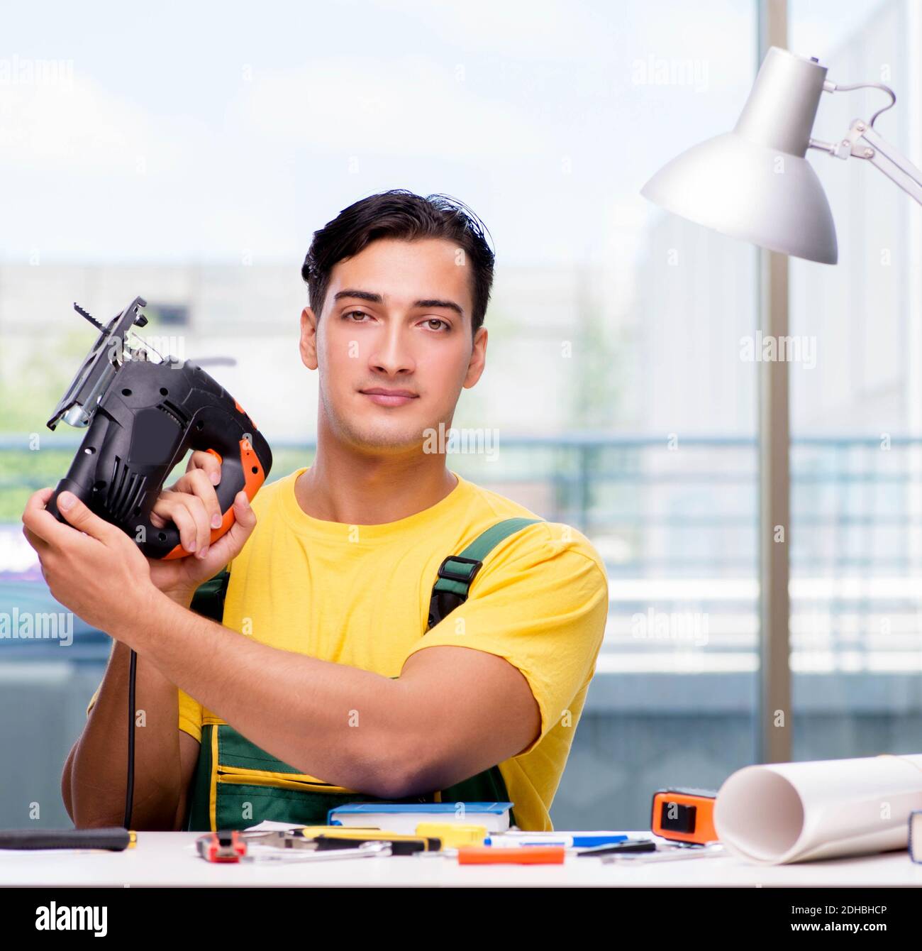 Construction worker sitting at the desk Stock Photo - Alamy