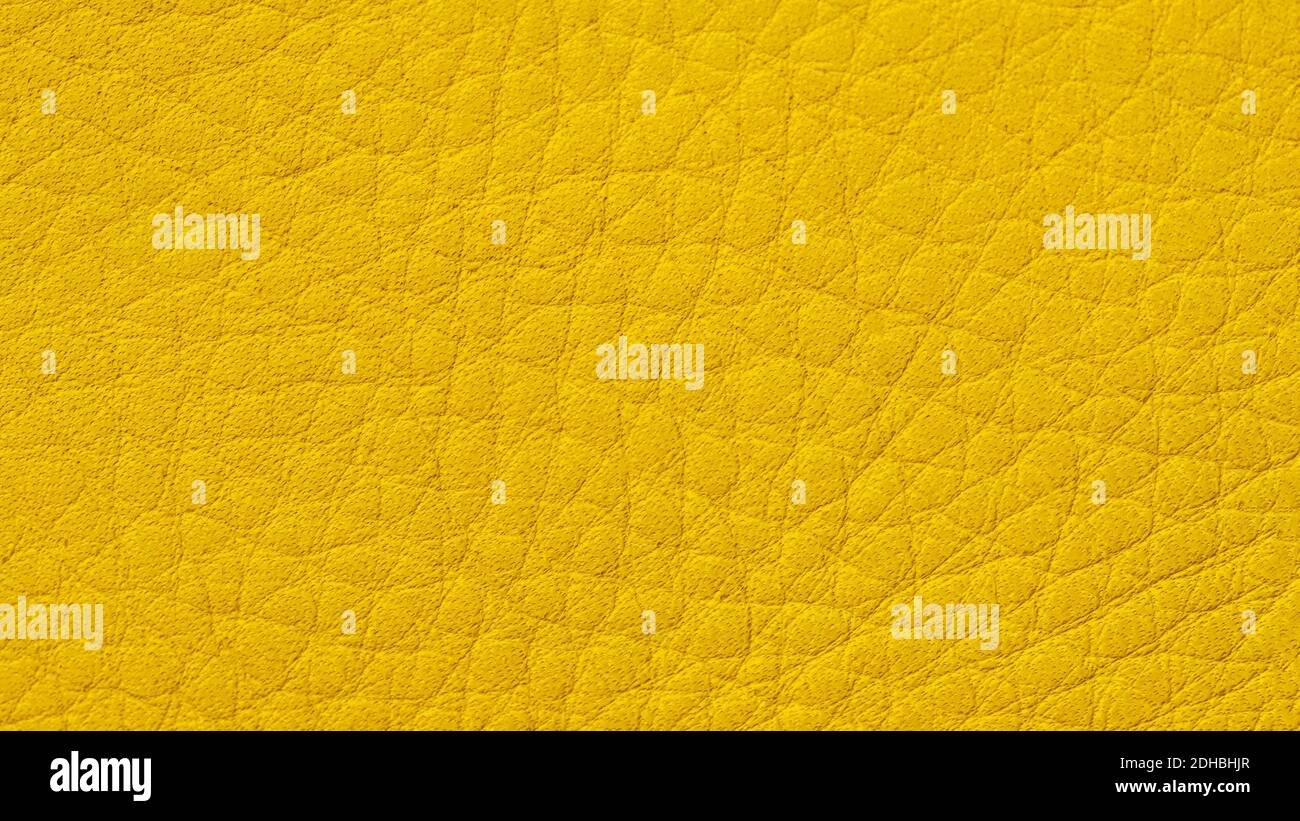 Texture of genuine leather close-up, yellow color. For bright ...
