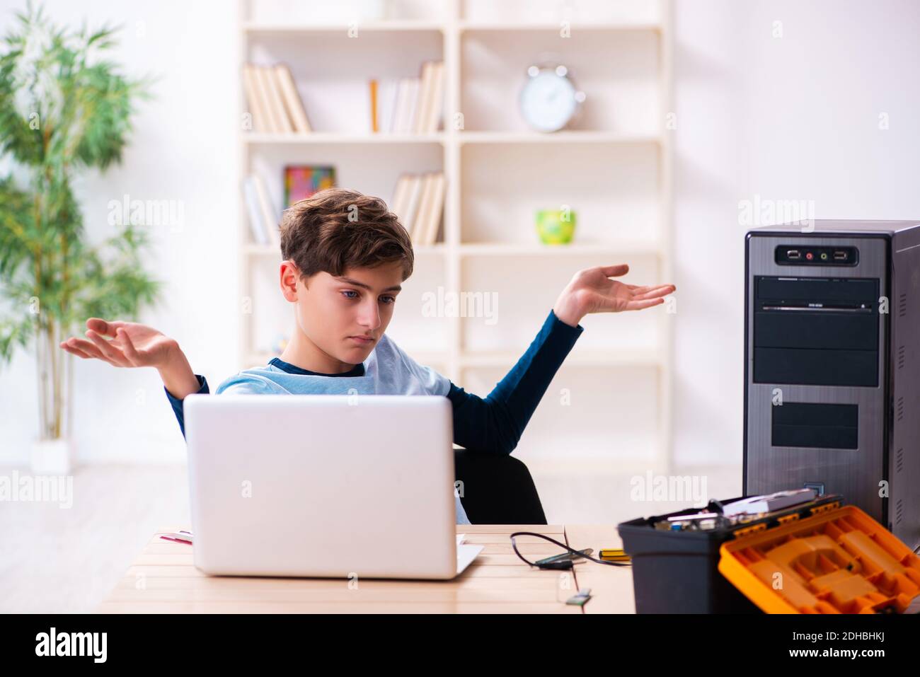 Boy reparing computers at workshop Stock Photo - Alamy