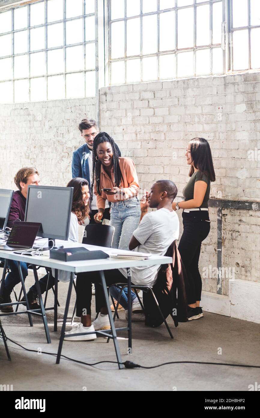 Team of happy computer hackers working together in creative office ...