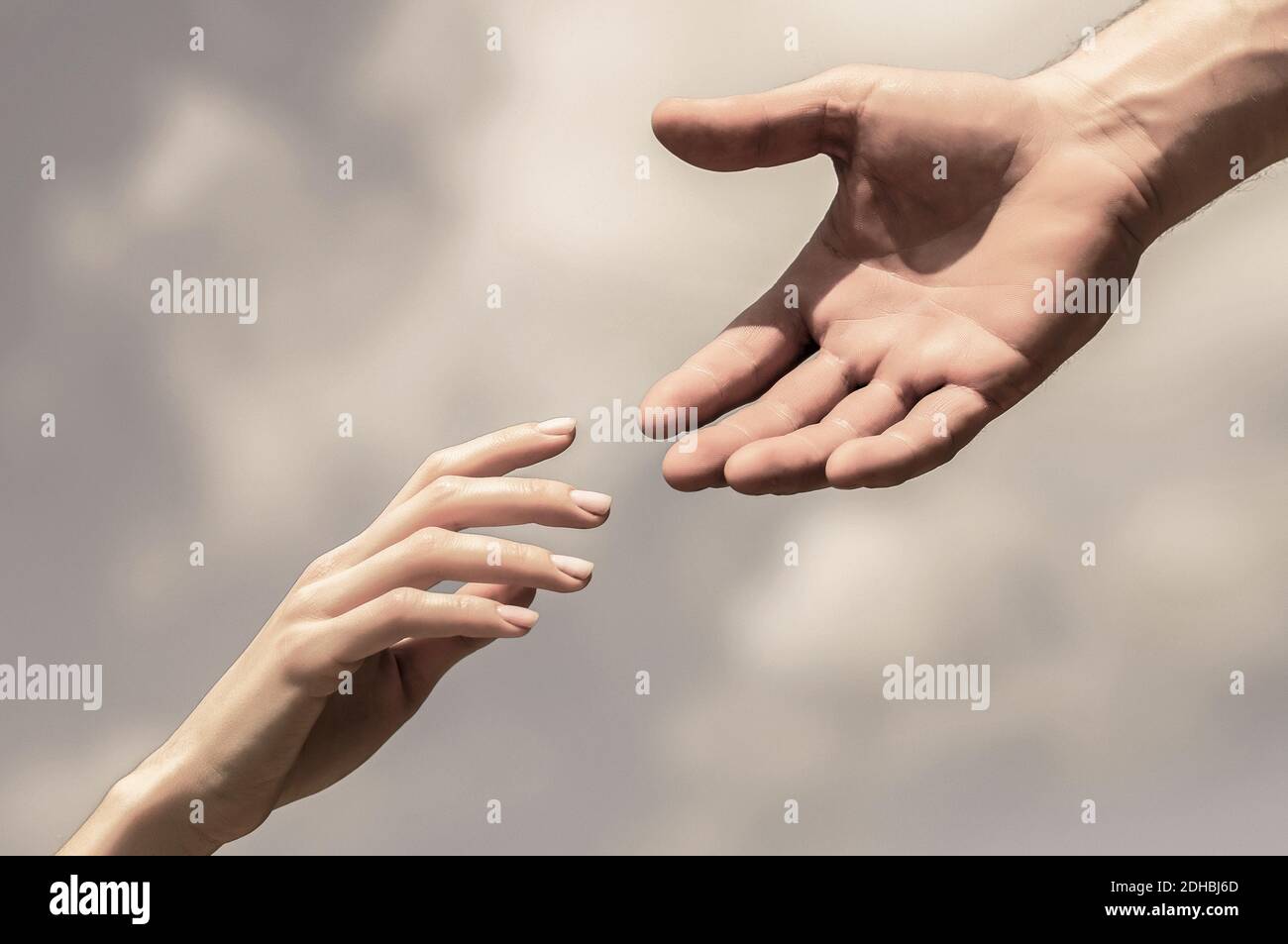 Giving a helping hand. Hands of man and woman on blue sky background ...