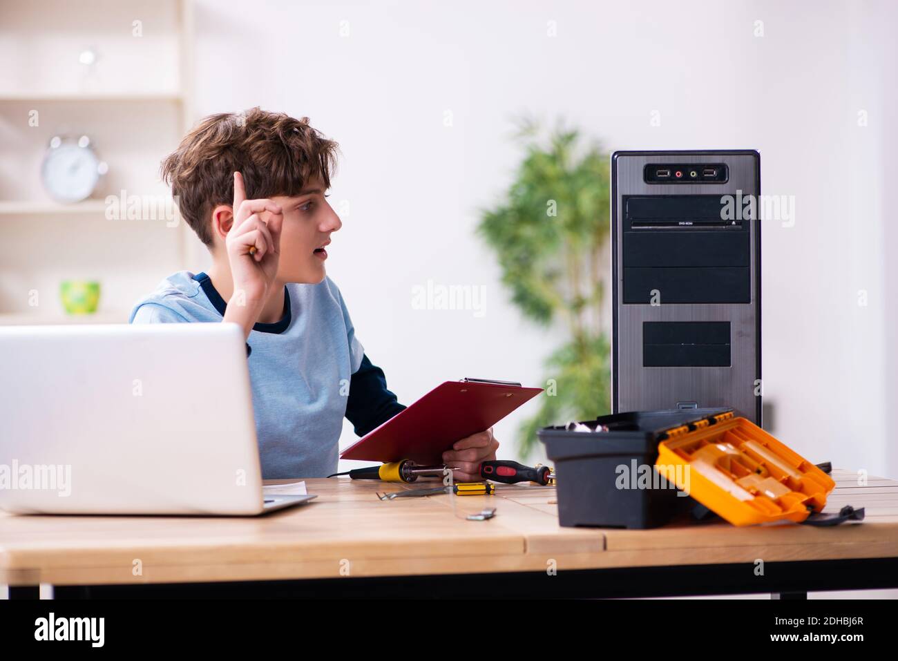 Boy reparing computers at workshop Stock Photo - Alamy
