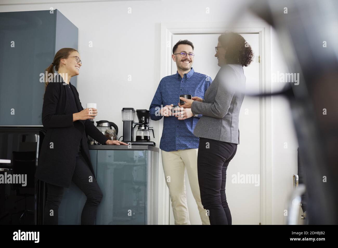 Office colleagues sharing coffee standing hi-res stock photography and images - Alamy