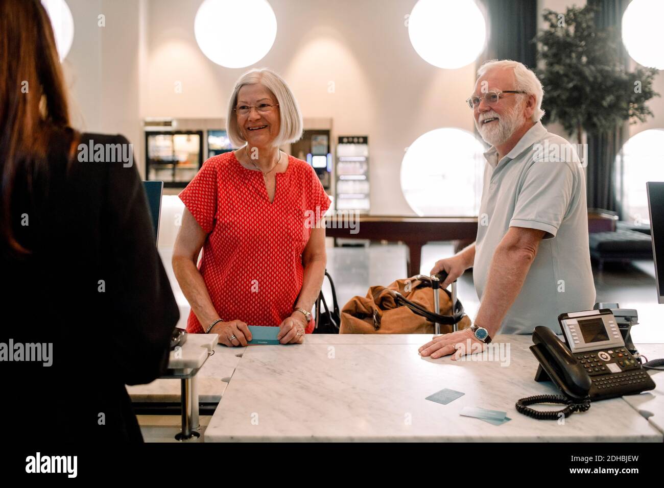 Receptionist standing in hotel lobby hi-res stock photography and ...