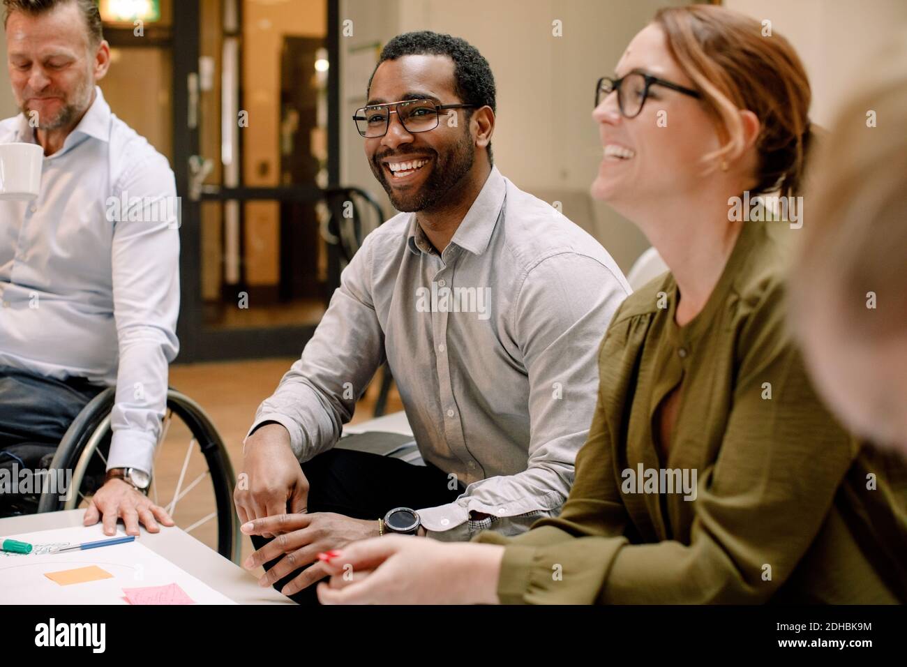 Business professionals smiling during sales meeting in office Stock ...