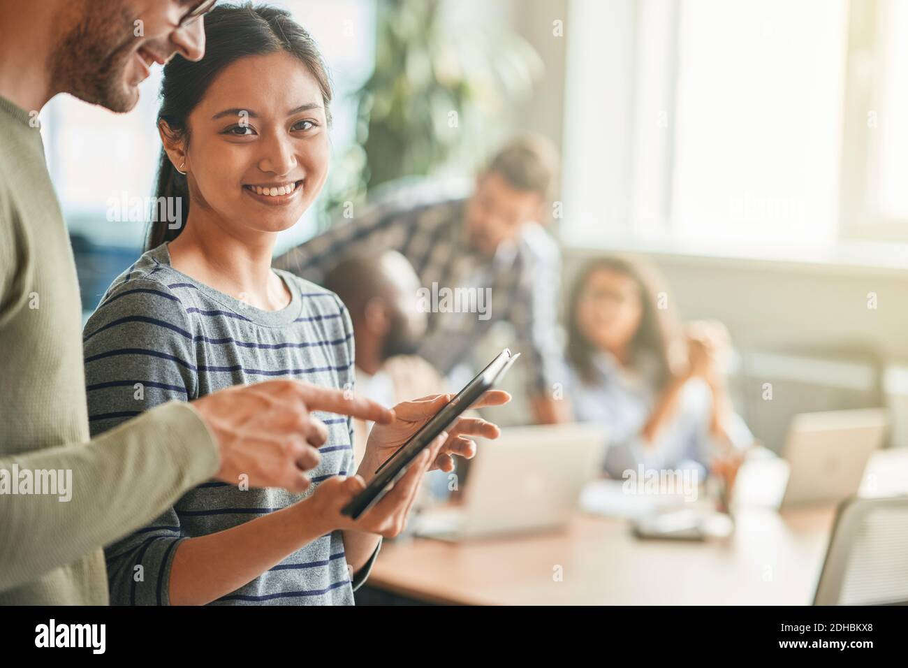 Happy woman achieving her goals while working in young company Stock ...