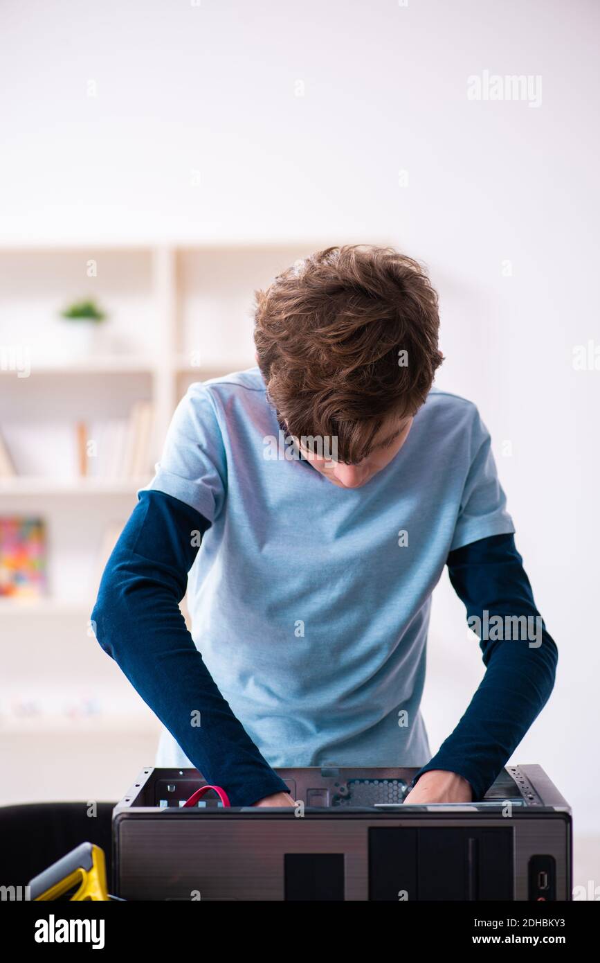 Boy reparing computers at workshop Stock Photo - Alamy