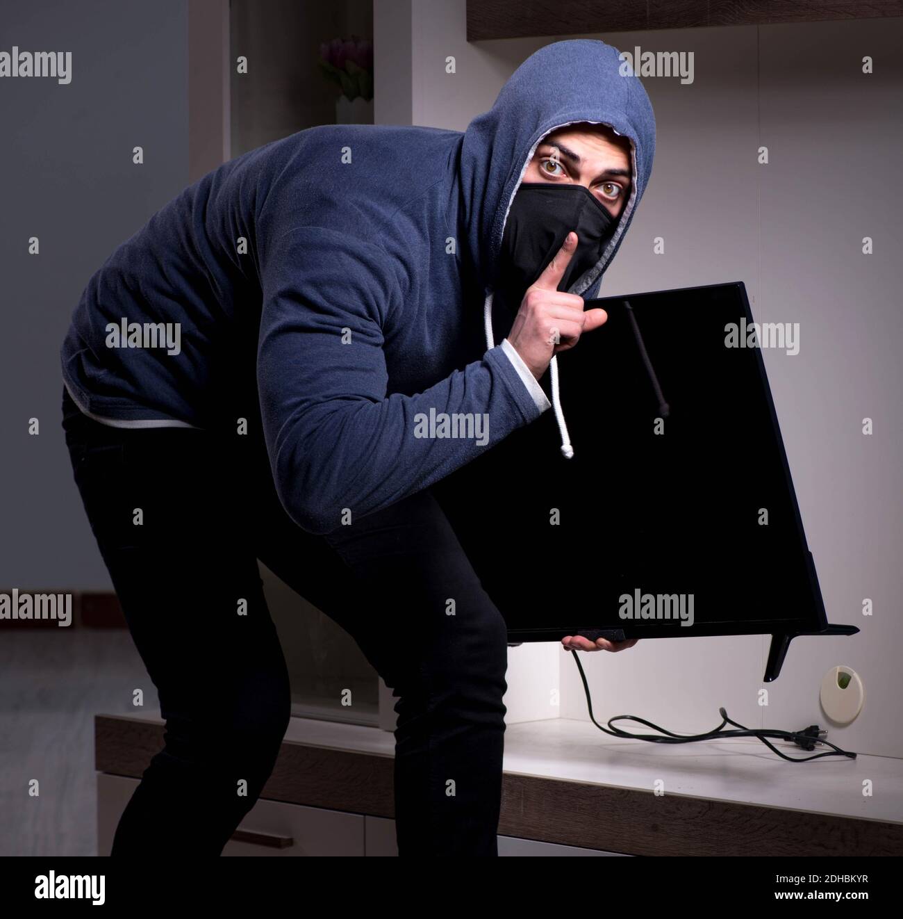 Burglar thief stealing tv from apartment house Stock Photo - Alamy
