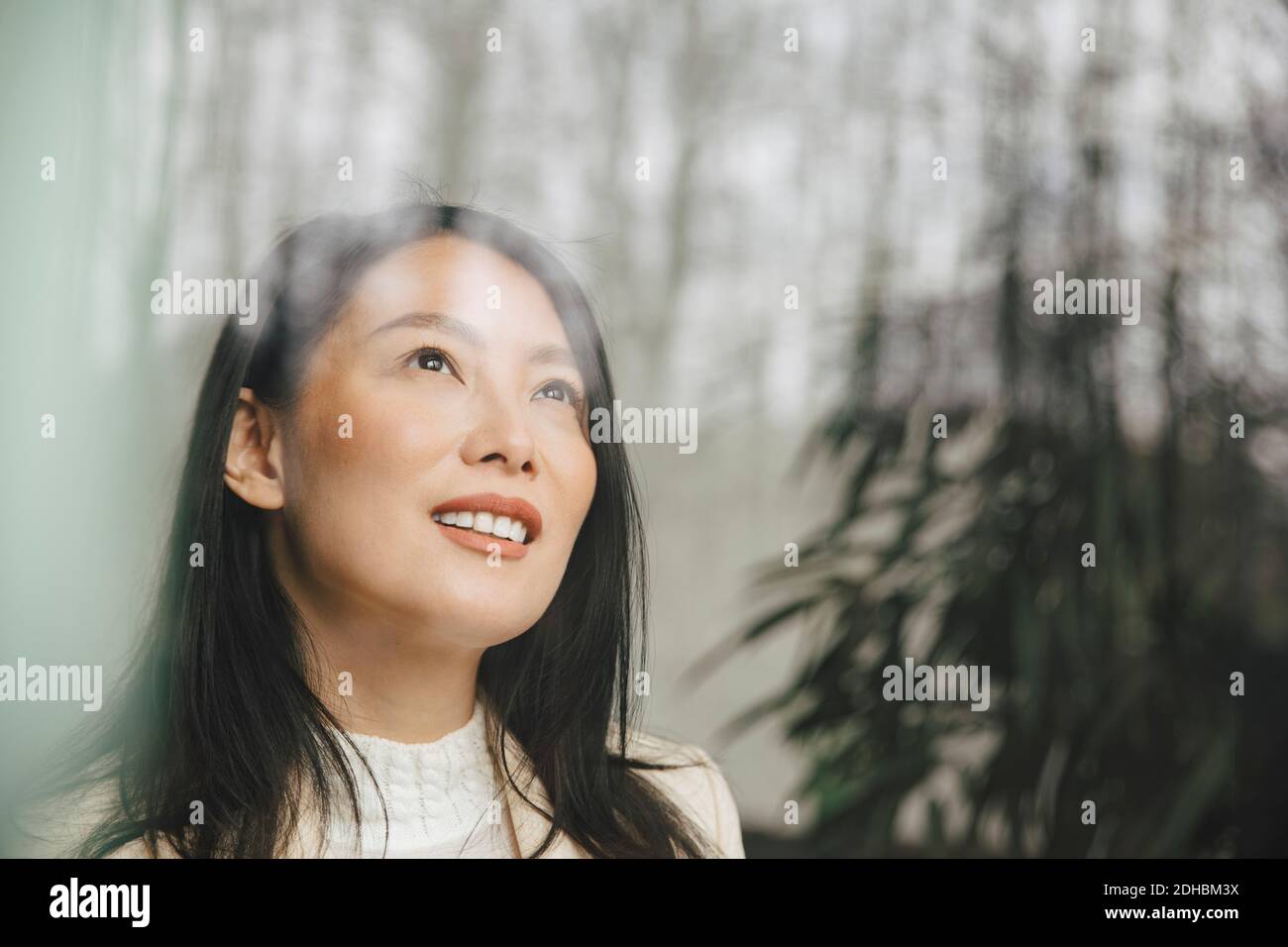 Indian girl looking through window hi-res stock photography and images ...