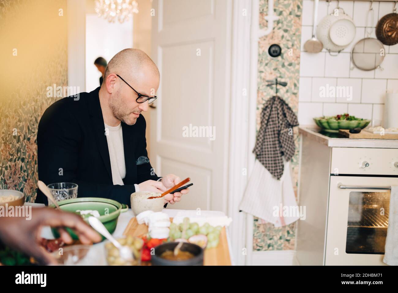 Using phone while eating dinner table hi-res stock photography and ...