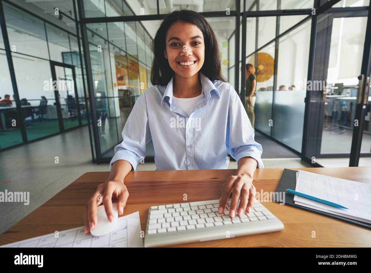 Hard-working young lady posing at her minimalistic workplace Stock ...