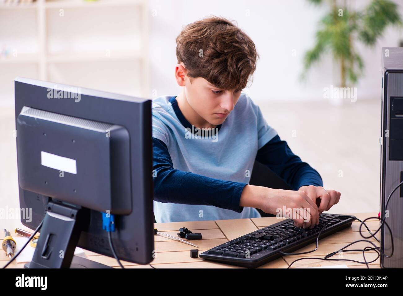 Boy reparing computers at workshop Stock Photo - Alamy