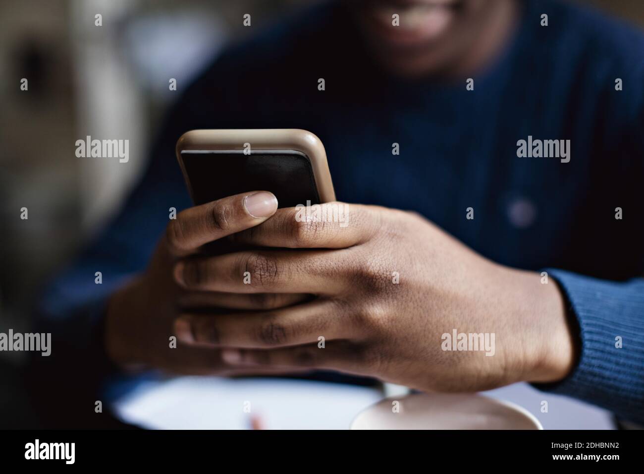 Social media addicted teenage boy using smart phone while studying at ...