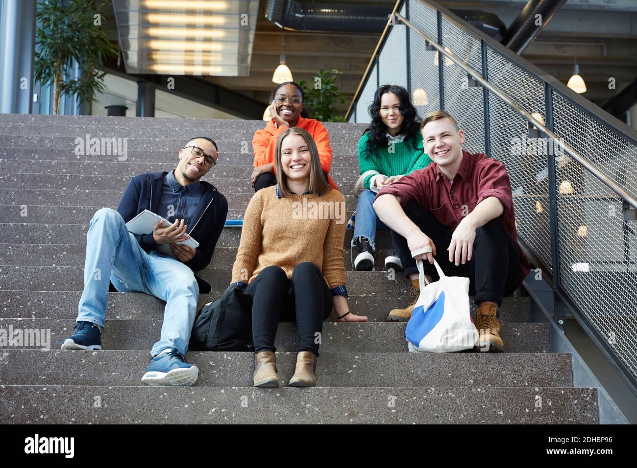 Five young students sitting hi-res stock photography and images - Alamy
