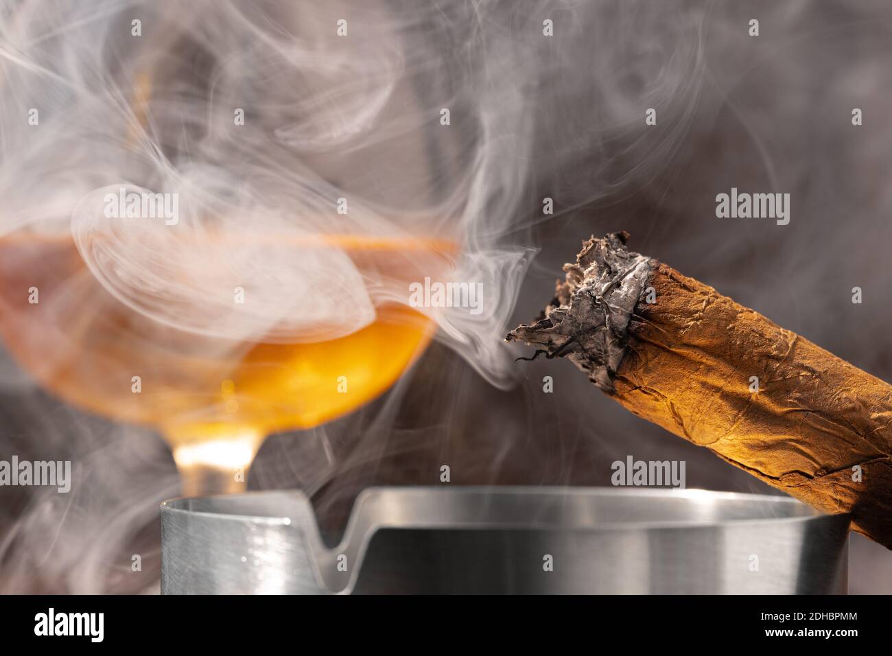 Glass of whisky and lighted cigar in an ash tray Stock Photo - Alamy
