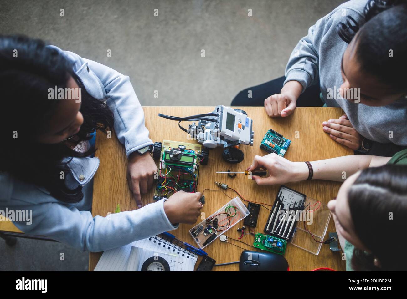 High angle view of multi-ethnic female students preparing science ...