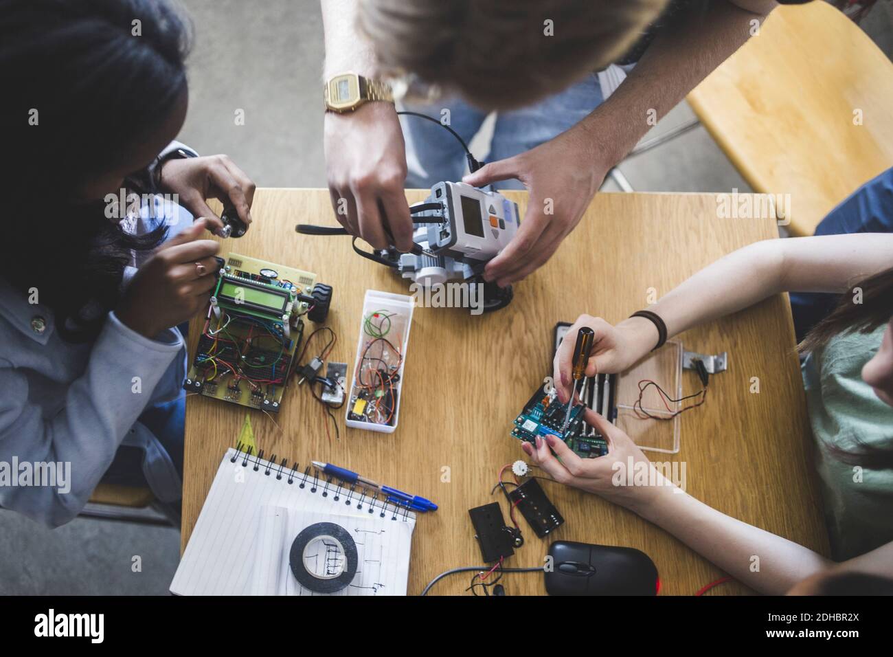 High angle view of multi-ethnic students preparing science project at ...