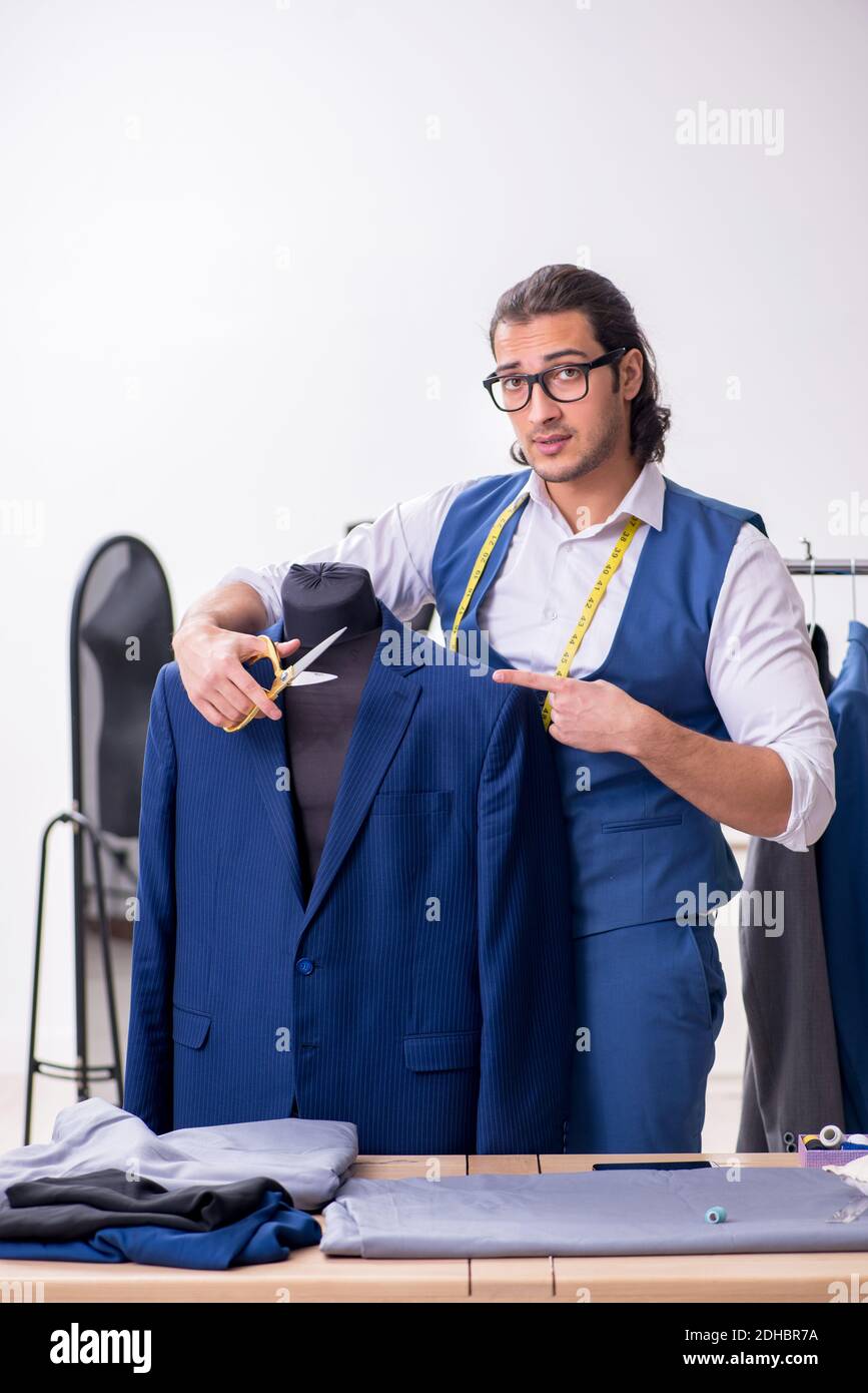 Young male tailor working at workshop Stock Photo - Alamy