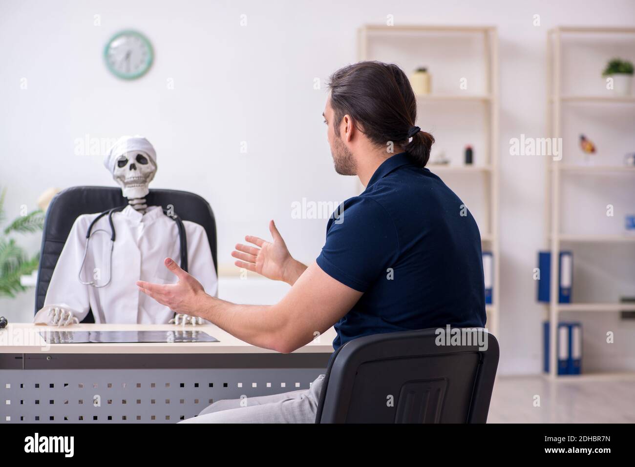 Young man visiting dead doctor Stock Photo - Alamy