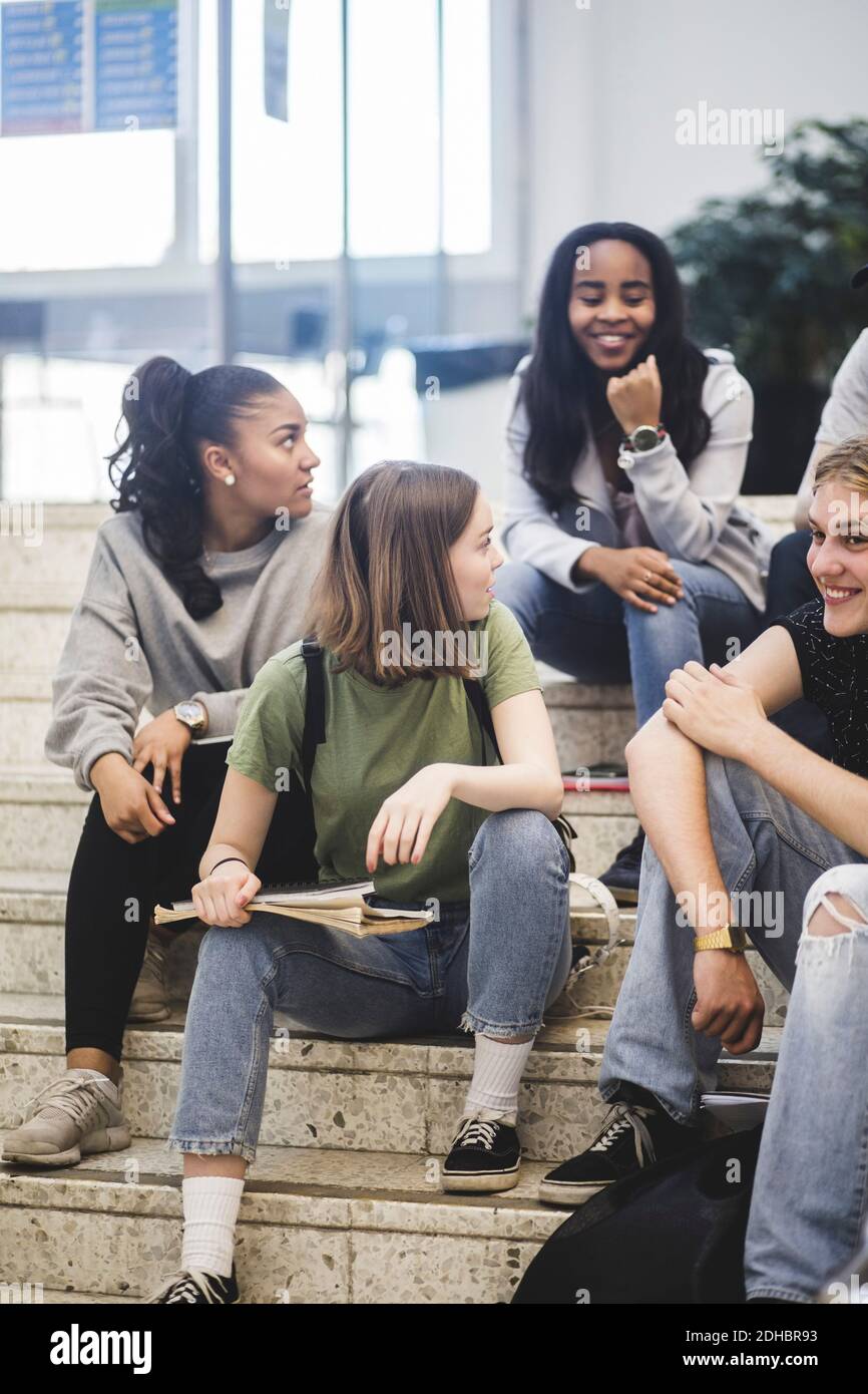 Smiling multi-ethnic high school students sitting on steps Stock Photo - Alamy