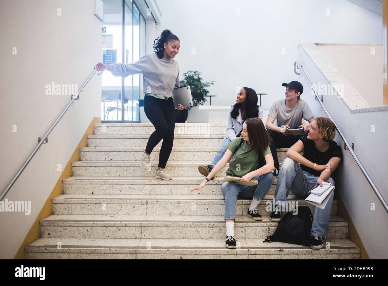 Smiling multi-ethnic students on staircase in high school Stock Photo ...