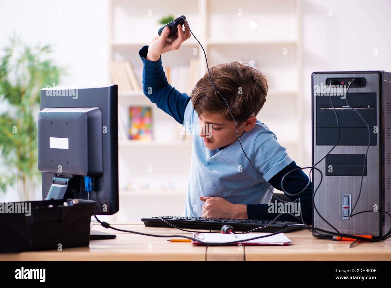 Boy reparing computers at workshop Stock Photo - Alamy