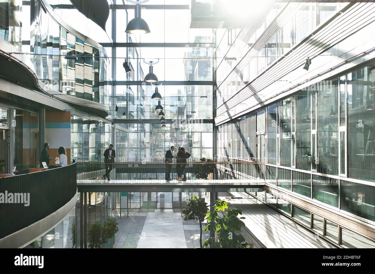 Business people standing in atrium at modern office Stock Photo - Alamy