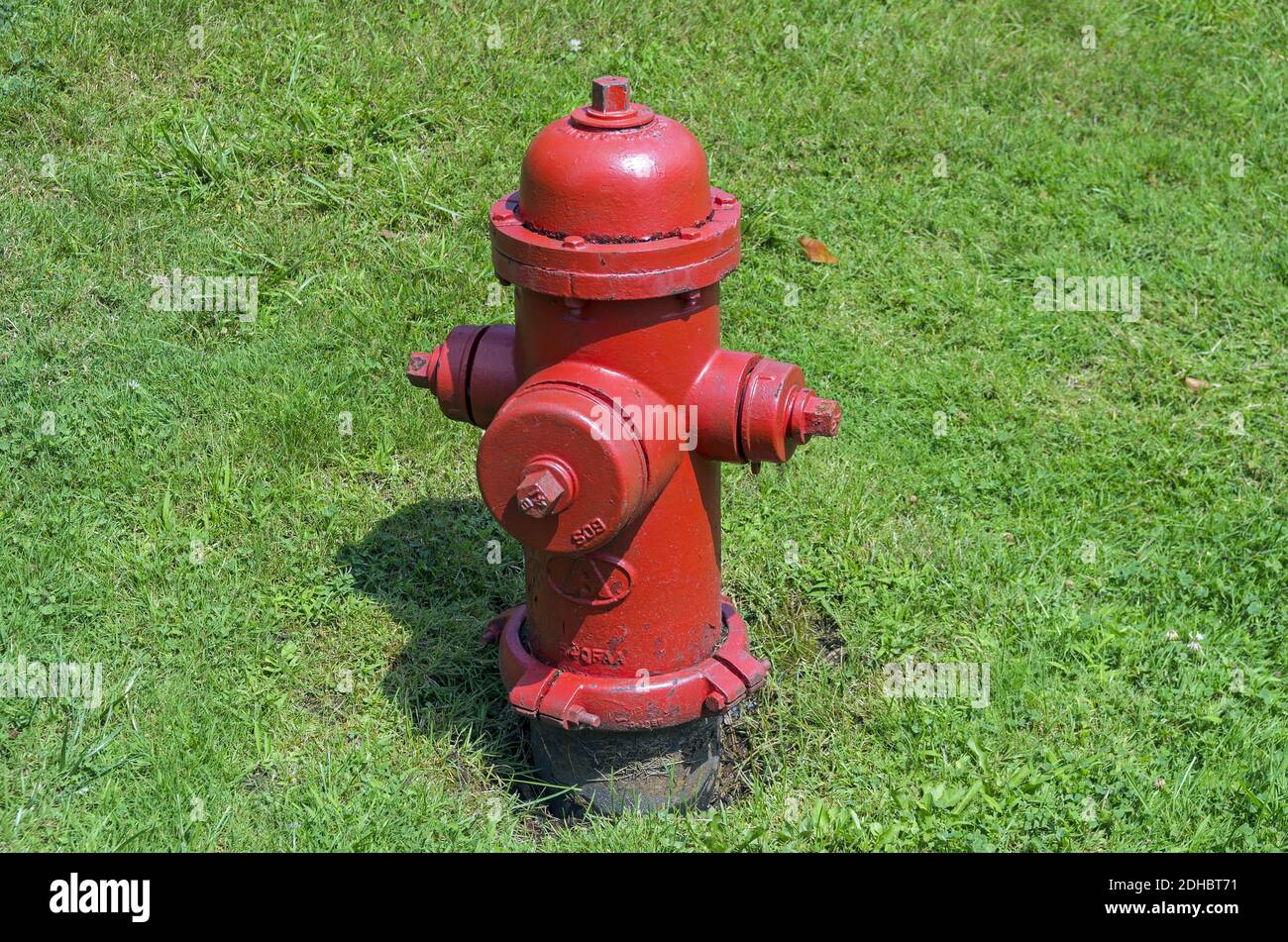 Red fire hydrant on a lawn Stock Photo - Alamy