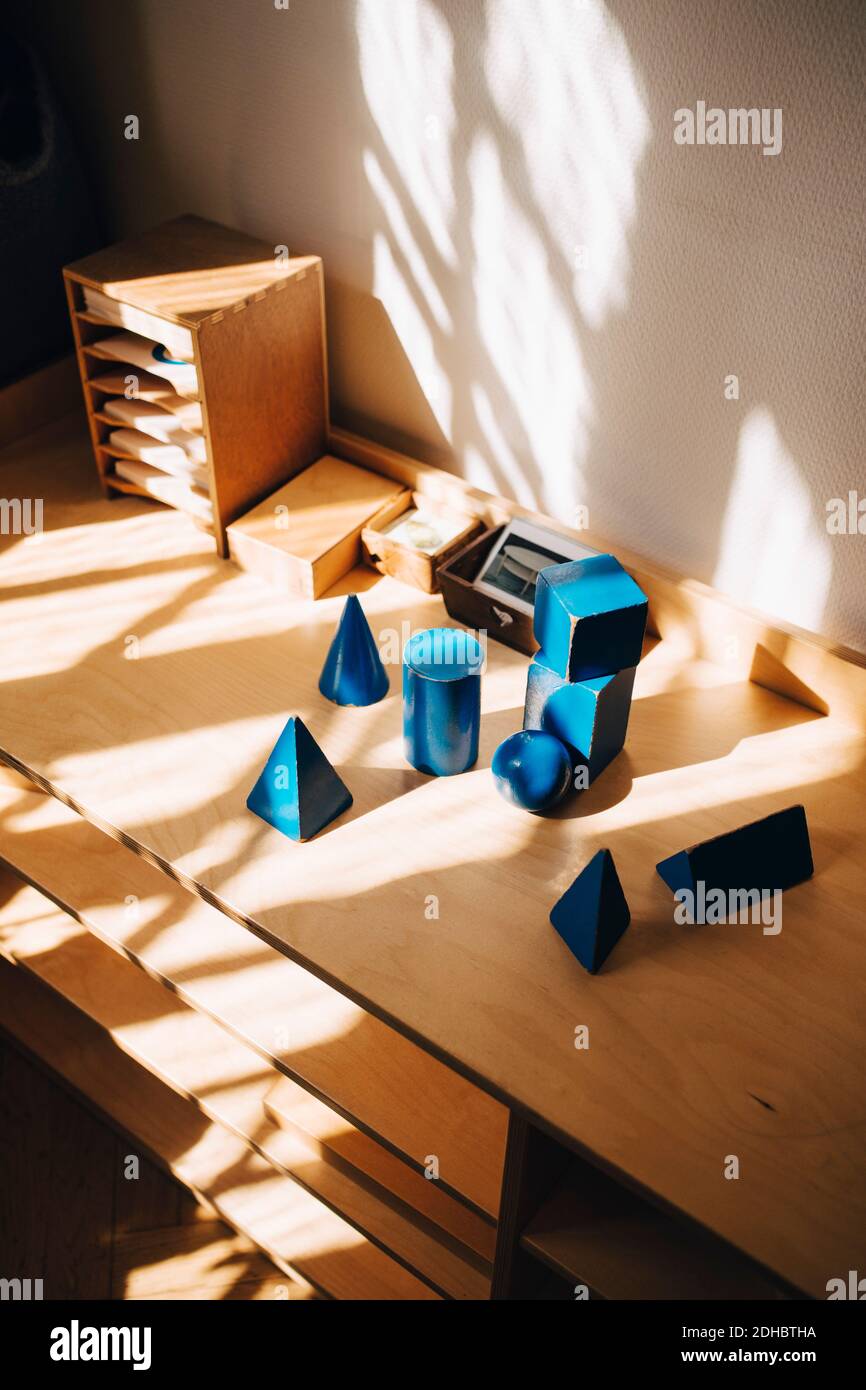 High angle view of toys on wooden table by wall in preschool classroom ...