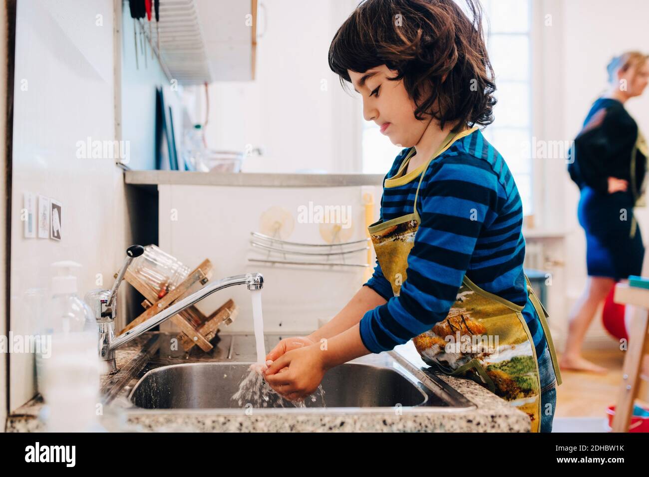 Child washing hands at sink hi-res stock photography and images - Alamy