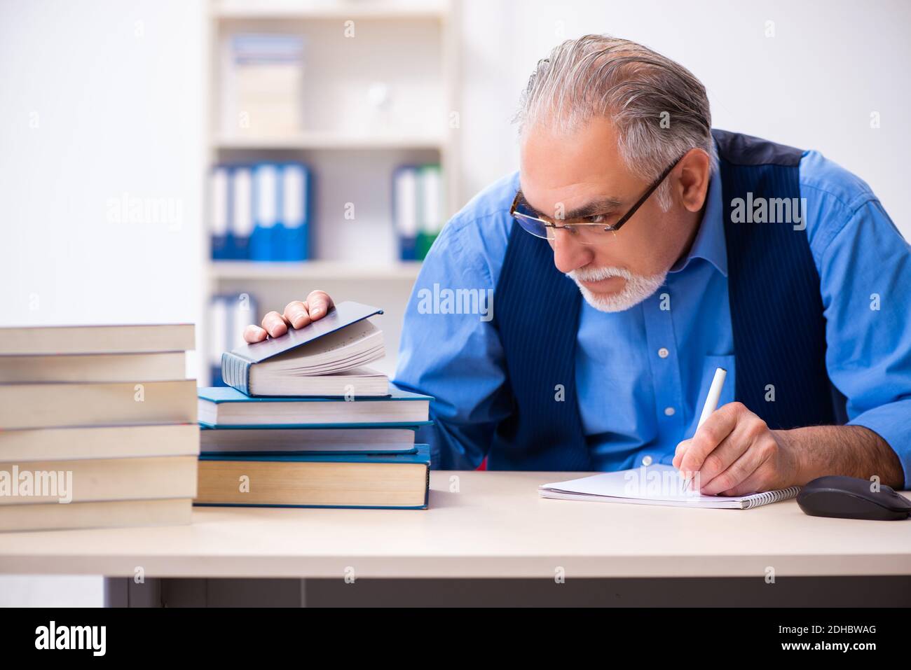 Old male author writing books Stock Photo - Alamy