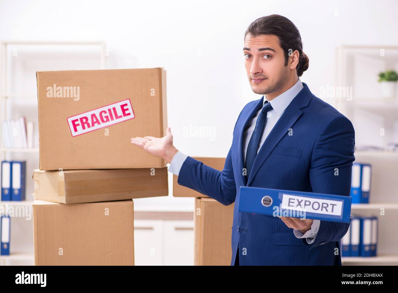 Young male logistics specialist working in the office Stock Photo - Alamy