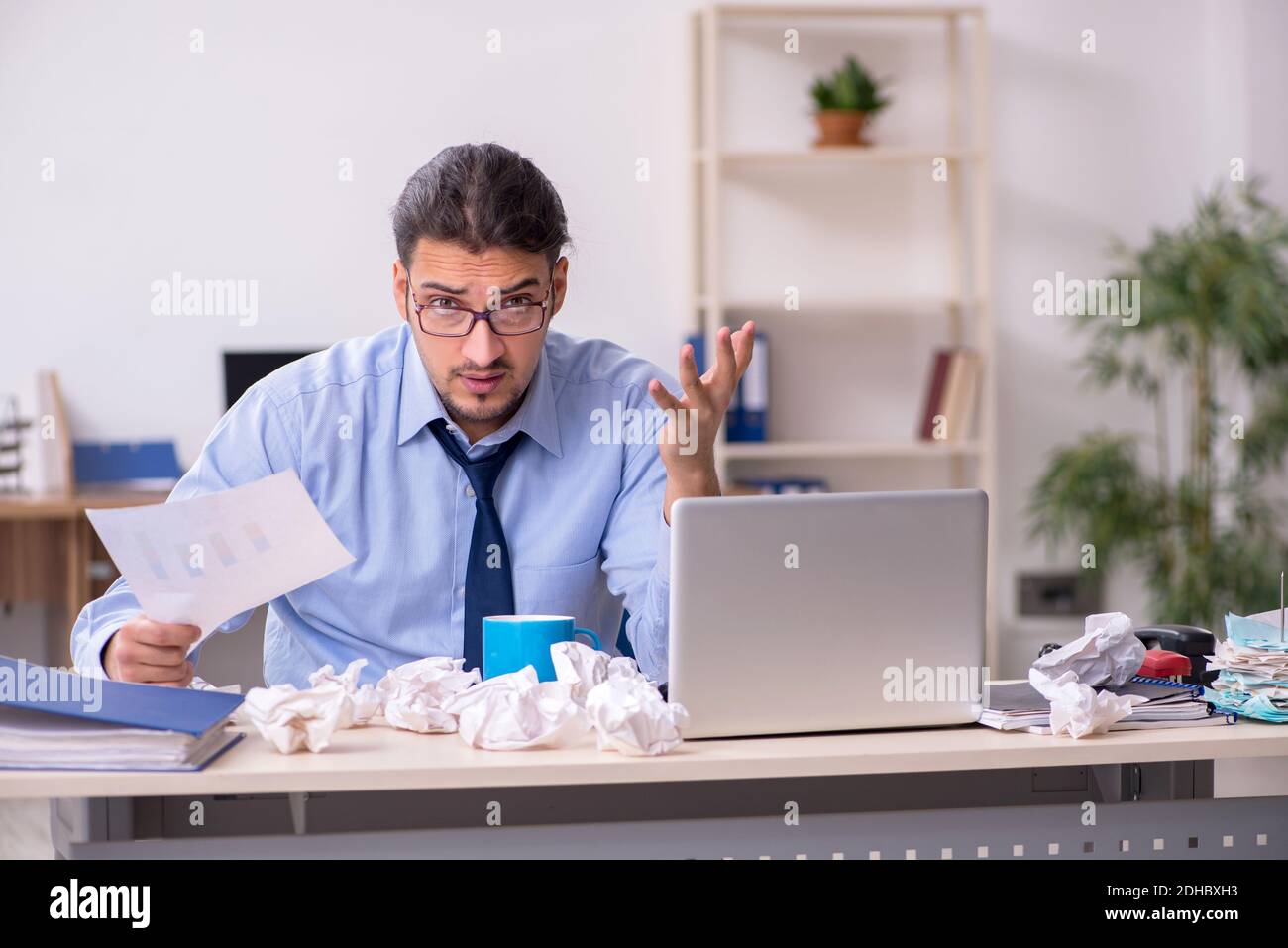 Sick male employee suffering at workplace Stock Photo - Alamy