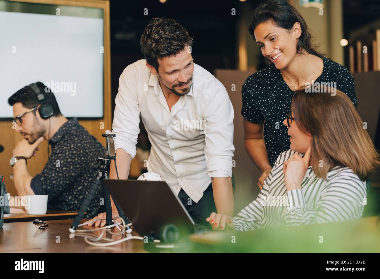 Multi-ethnic business people having discussion at table in creative ...
