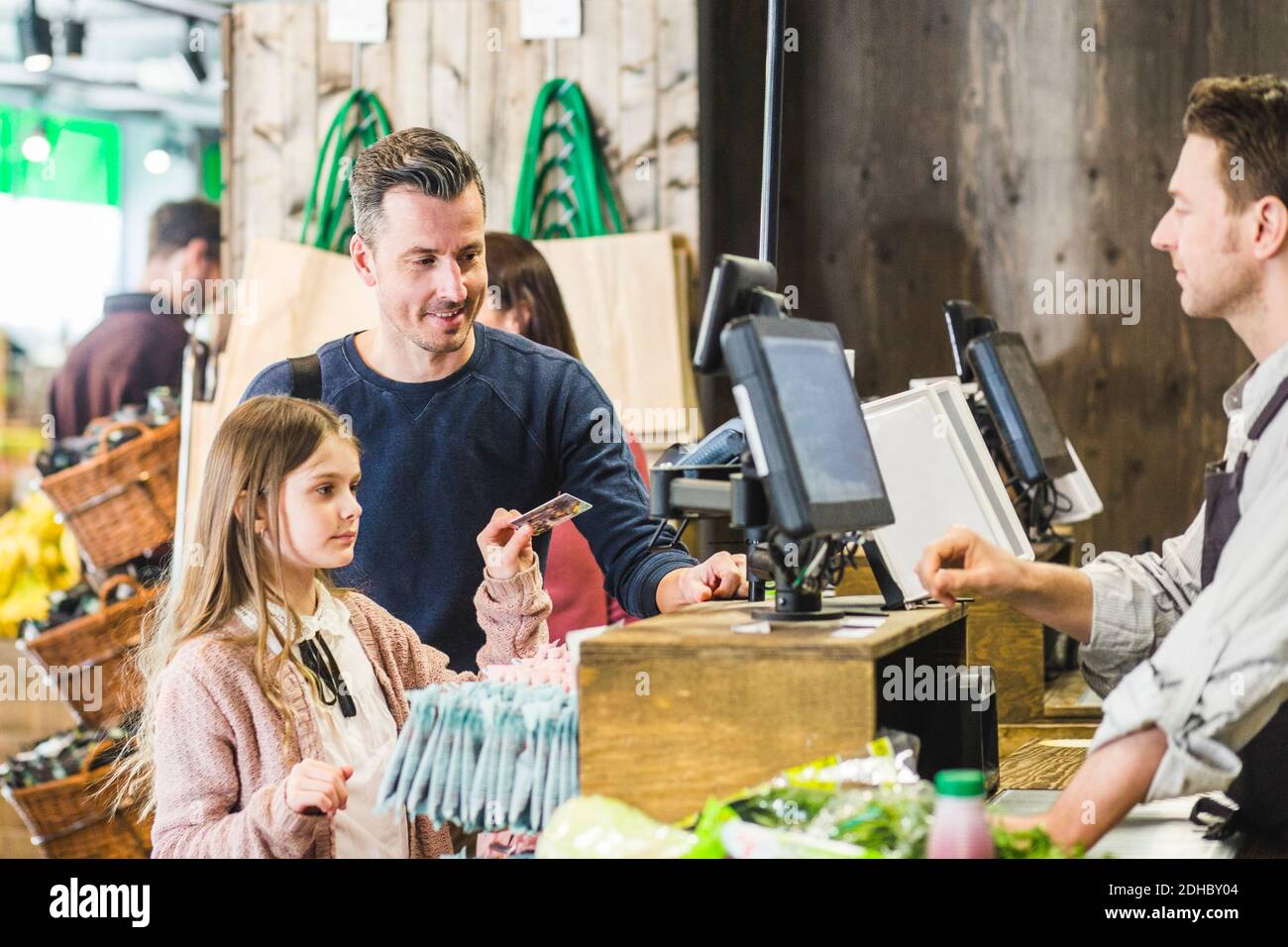 Child paying store clerk hi-res stock photography and images - Alamy
