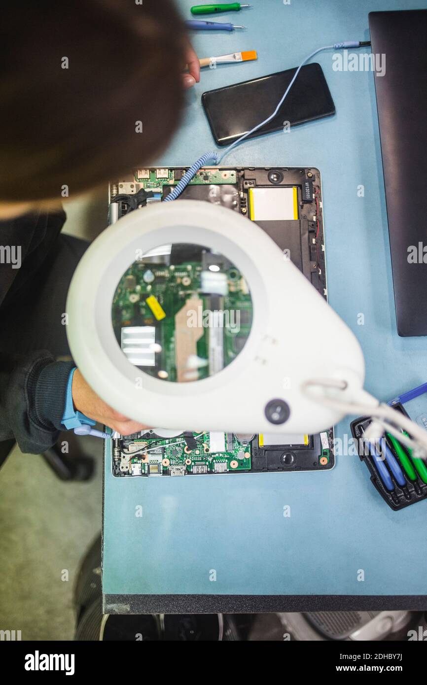High angle view of technician repairing in computer store with ...