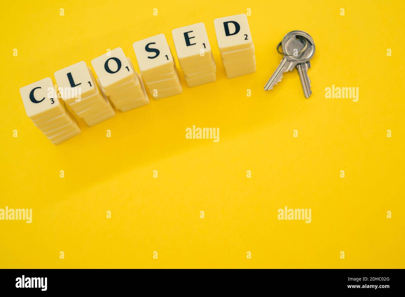 The six white letter block stacks forming the word CLOSED with keys on ...
