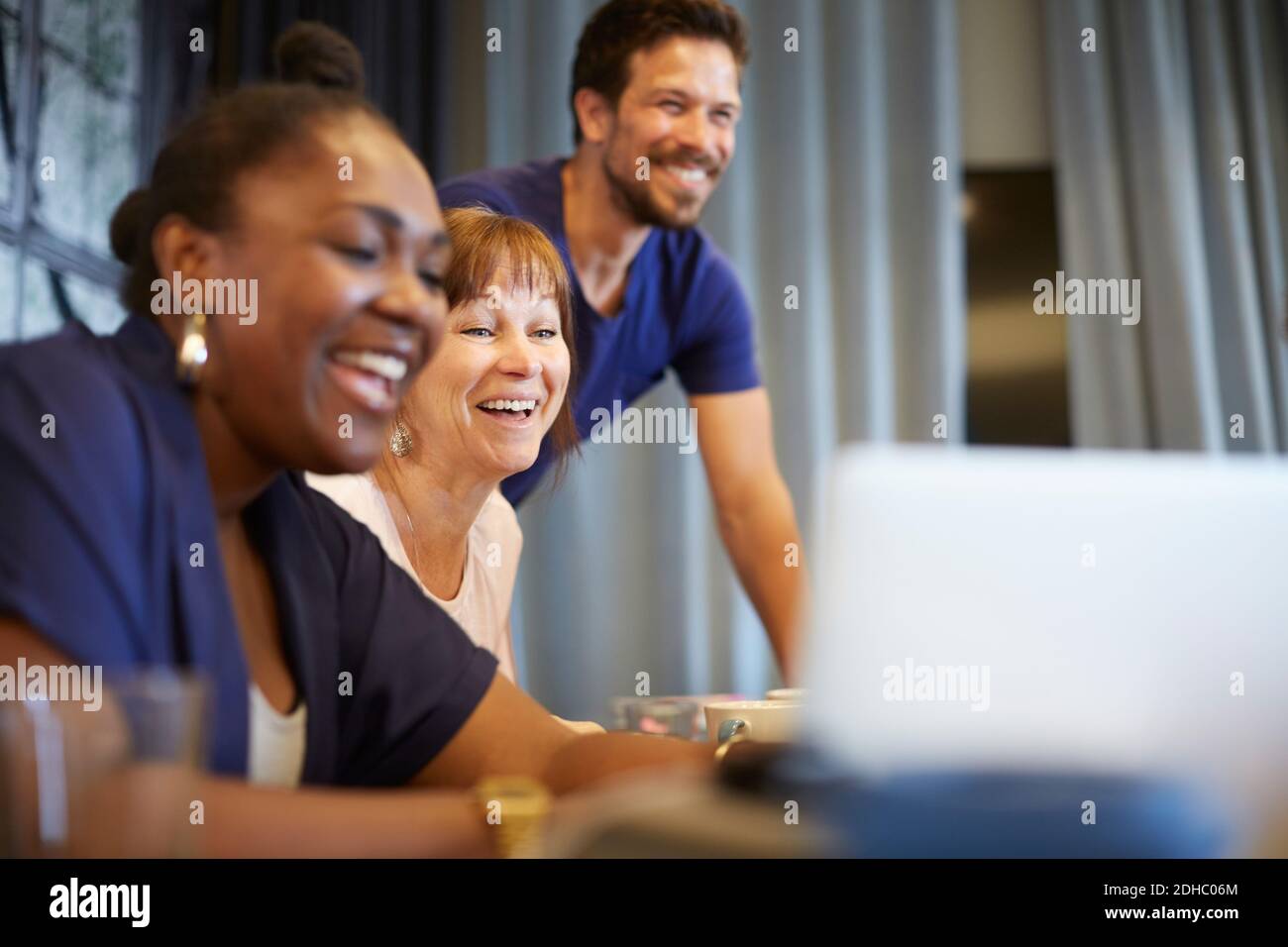 Creative business people smiling during meeting in office Stock Photo ...