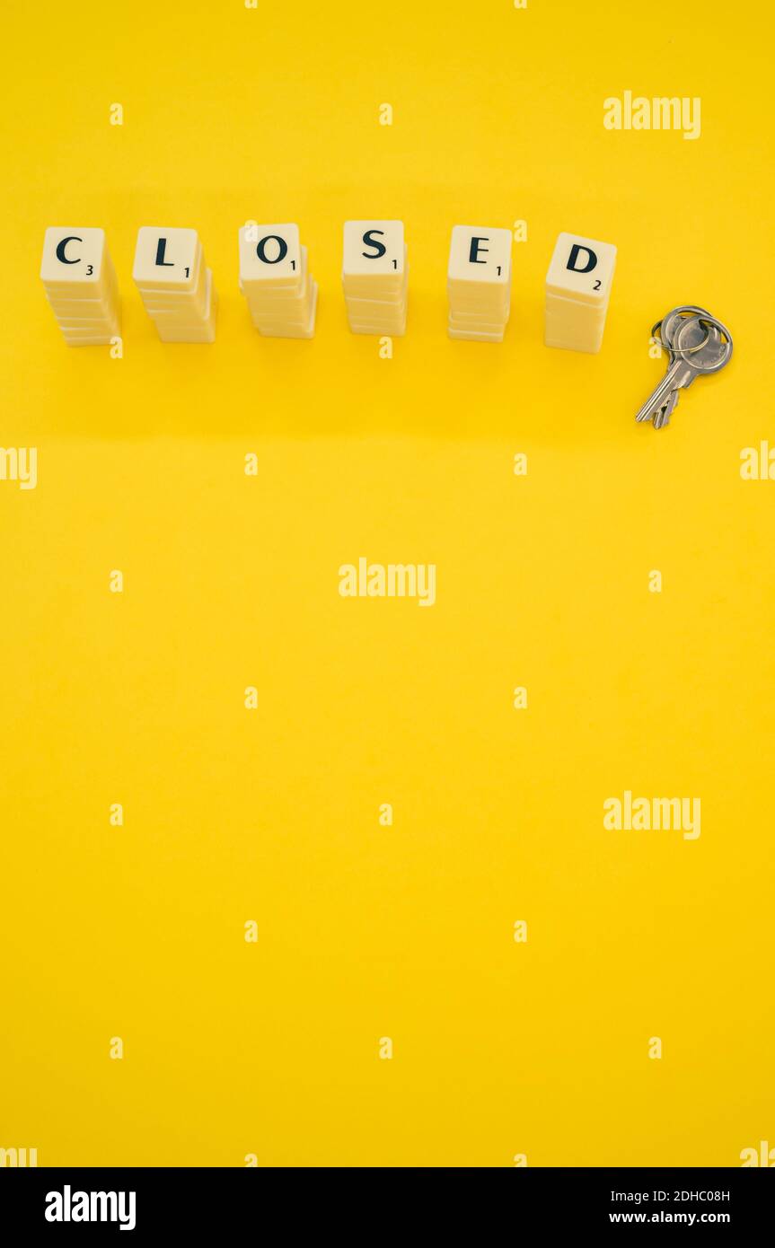 The six white letter block stacks forming the word CLOSED with keys on ...