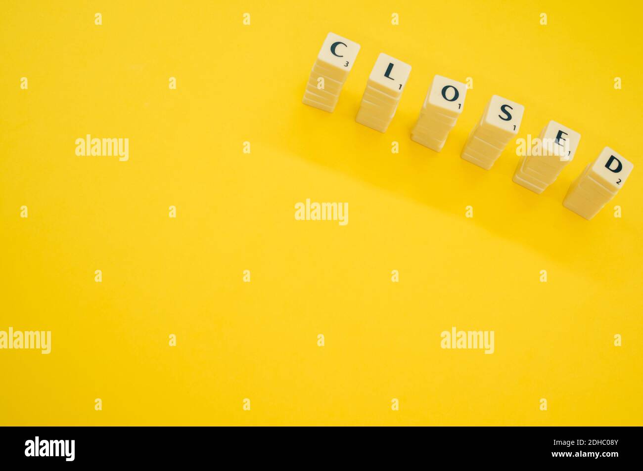 The six white letter block stacks forming the word CLOSED on yellow ...