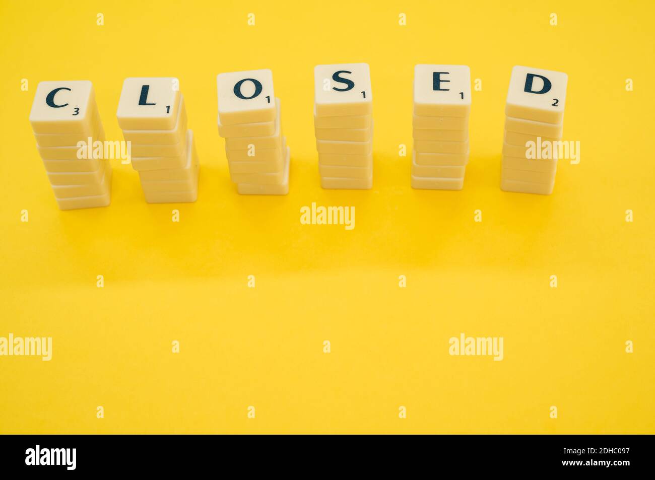 The six white letter block stacks forming the word CLOSED on yellow ...